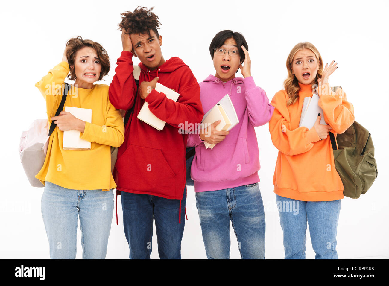 Image of confused shocked young group of friends students standing ...