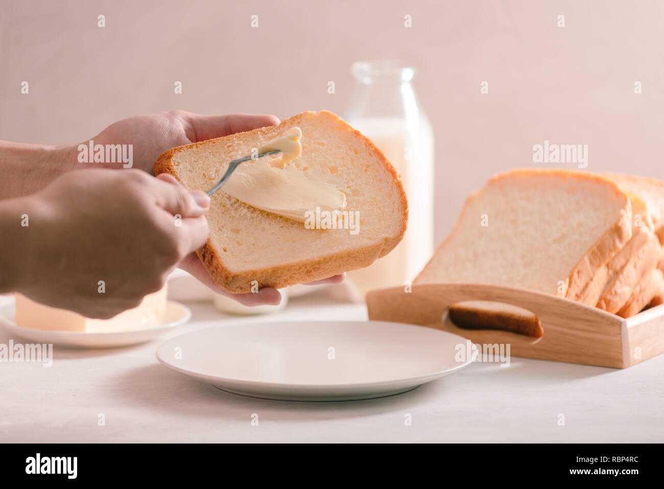Child cutting a slice of bread hi-res stock photography and images - Alamy