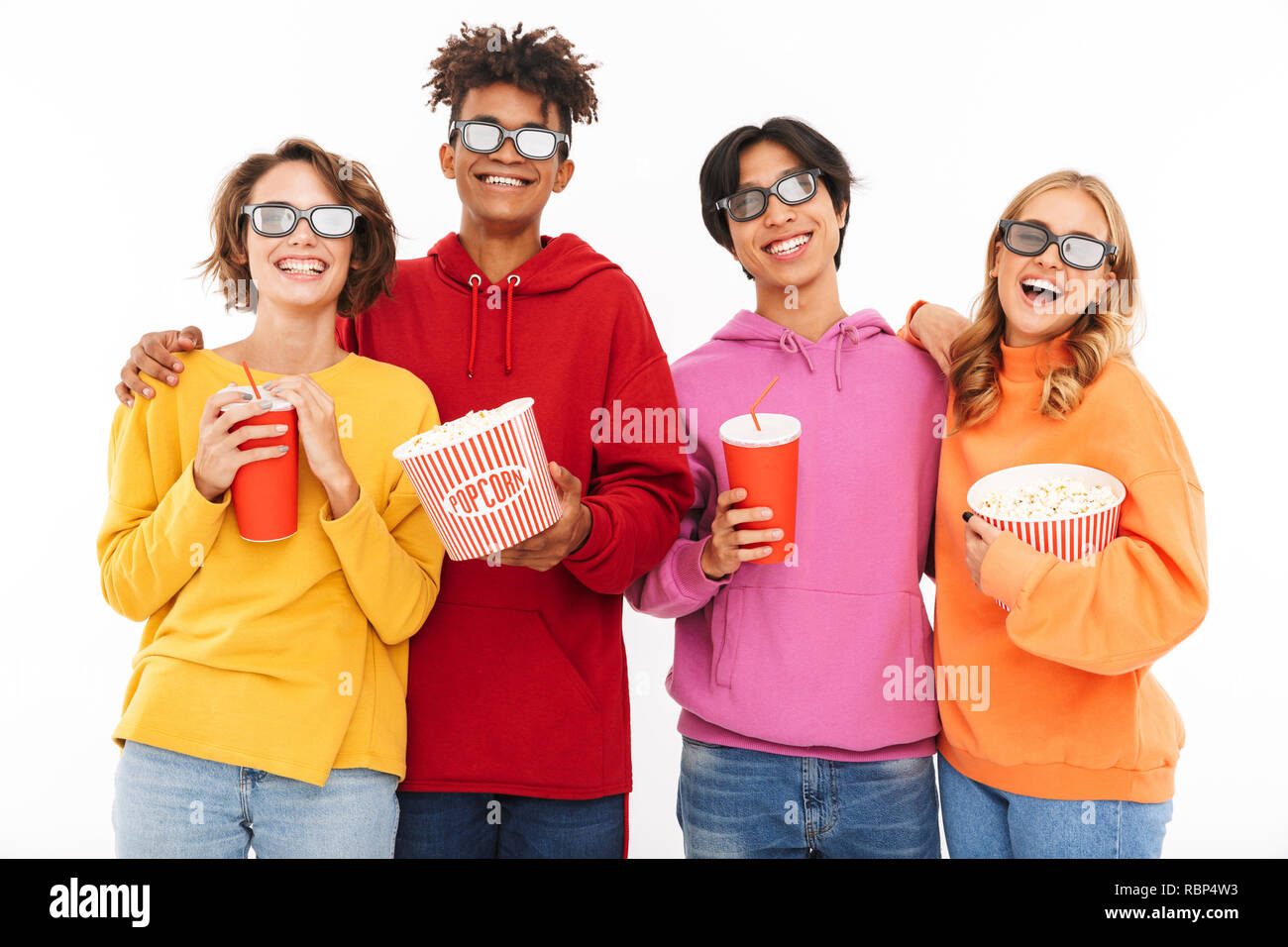 Group of cheerful multiracial friends watching a movie, eating popcorn ...