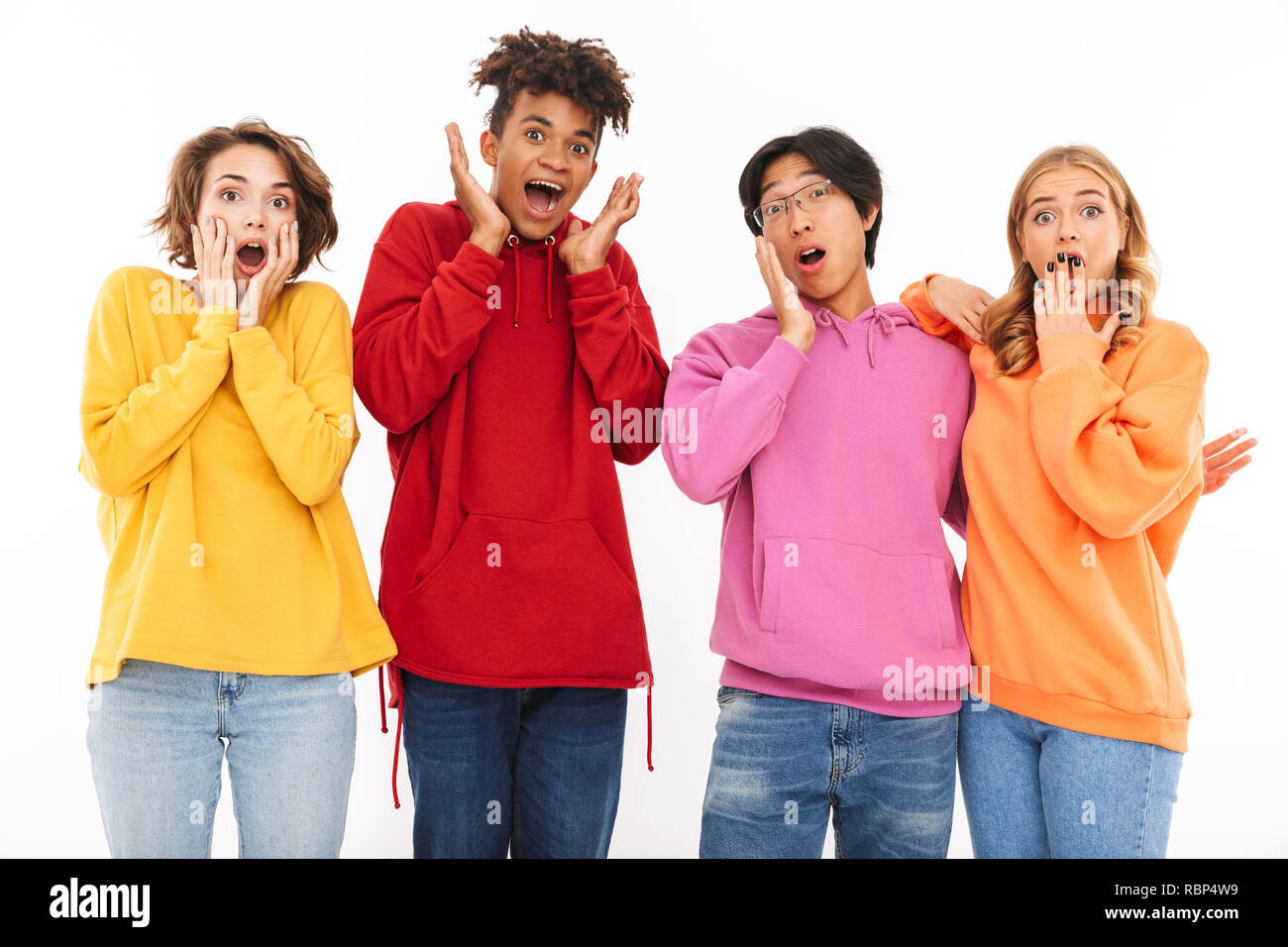 Group of shocked multiracial friends standing isolated over white Stock ...