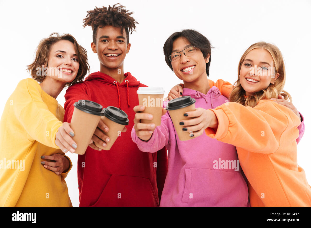 Group of cheerful teenagers isolated over white background, toasting ...