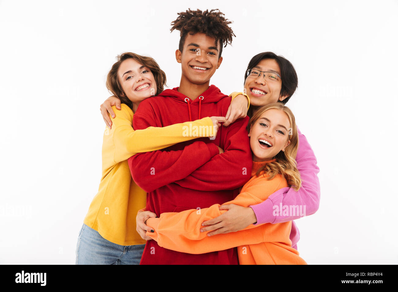 Group of cheerful teenagers isolated over white background, hugging ...