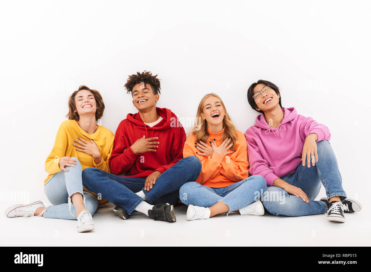 Group of cheerful multiracial friends sitting isolated over white ...