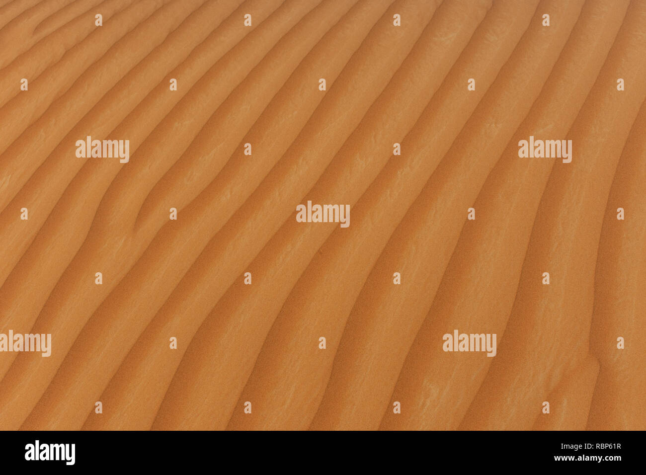 Rippling sand dunes background in the beautiful sunshine Stock Photo ...