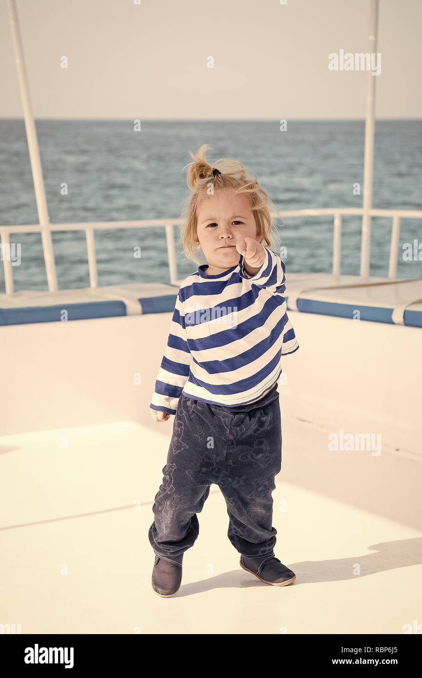 adorable cute little baby captain on boat or sailing yacht on summer ...