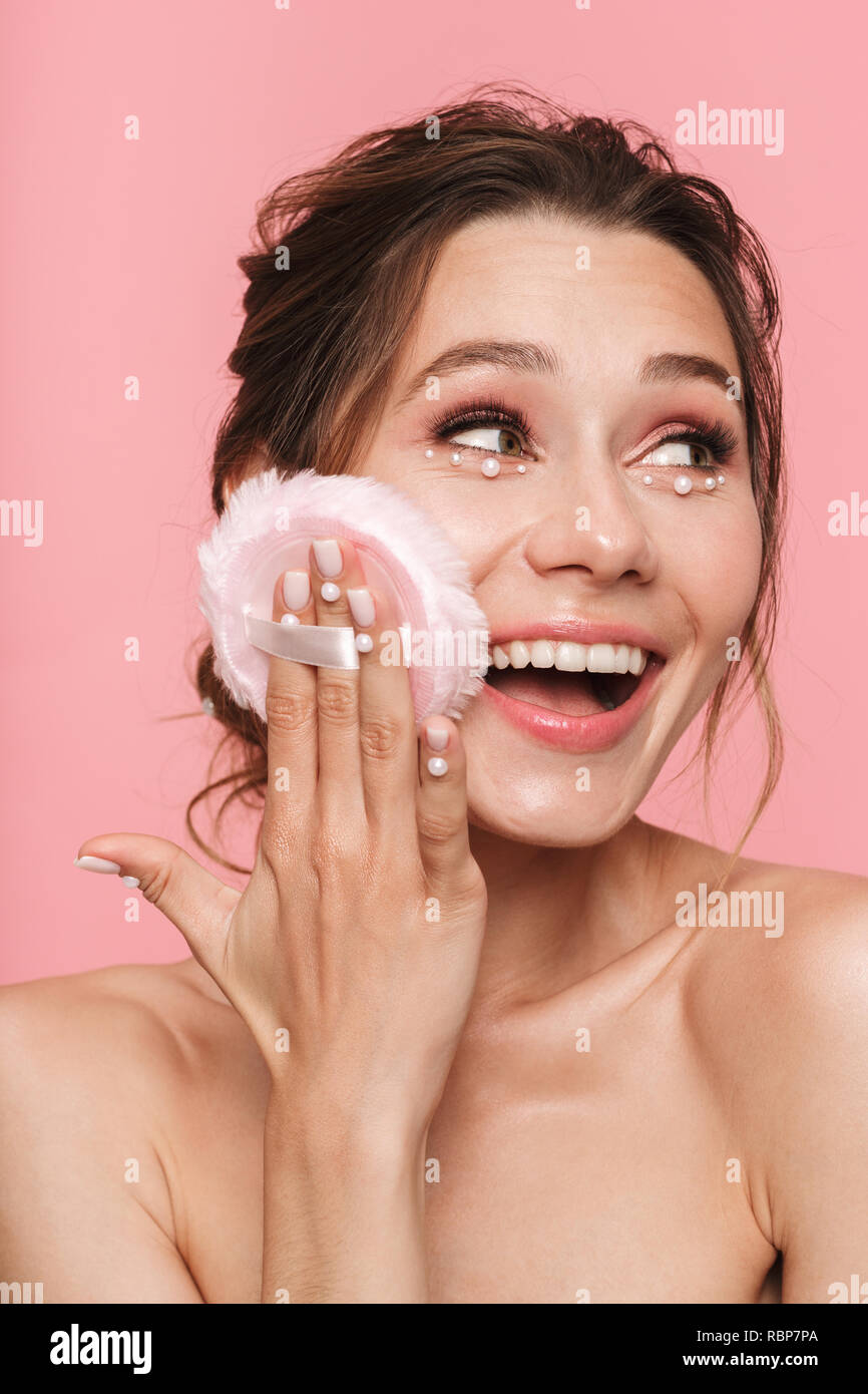 Image of a pretty young woman posing isolated over pink wall background ...