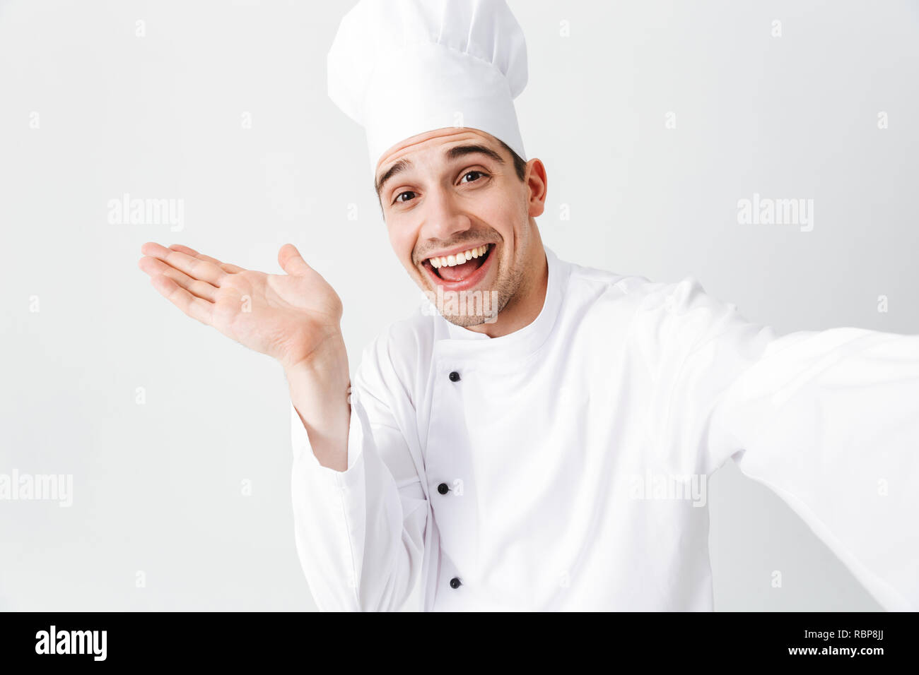 Happy chef cook wearing uniform standing isolated over white background ...
