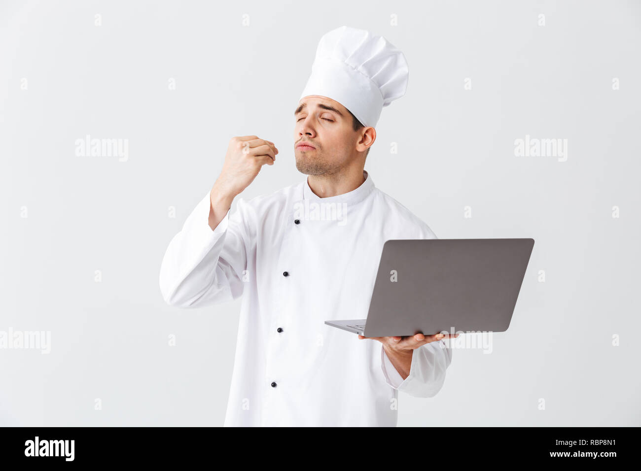Cheerful chef cook wearing uniform standing over white background ...