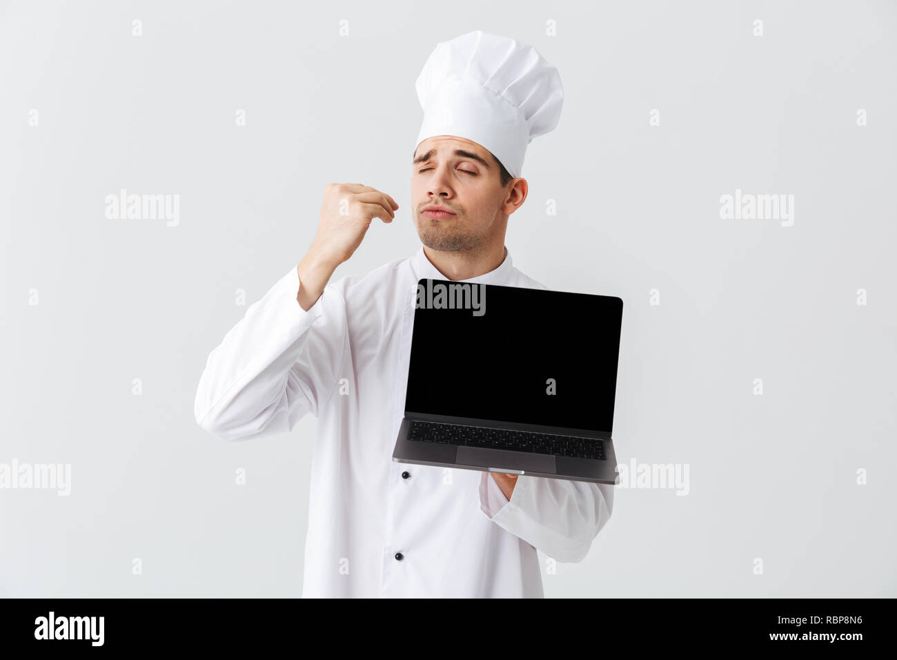 Cheerful chef cook wearing uniform standing over white background ...