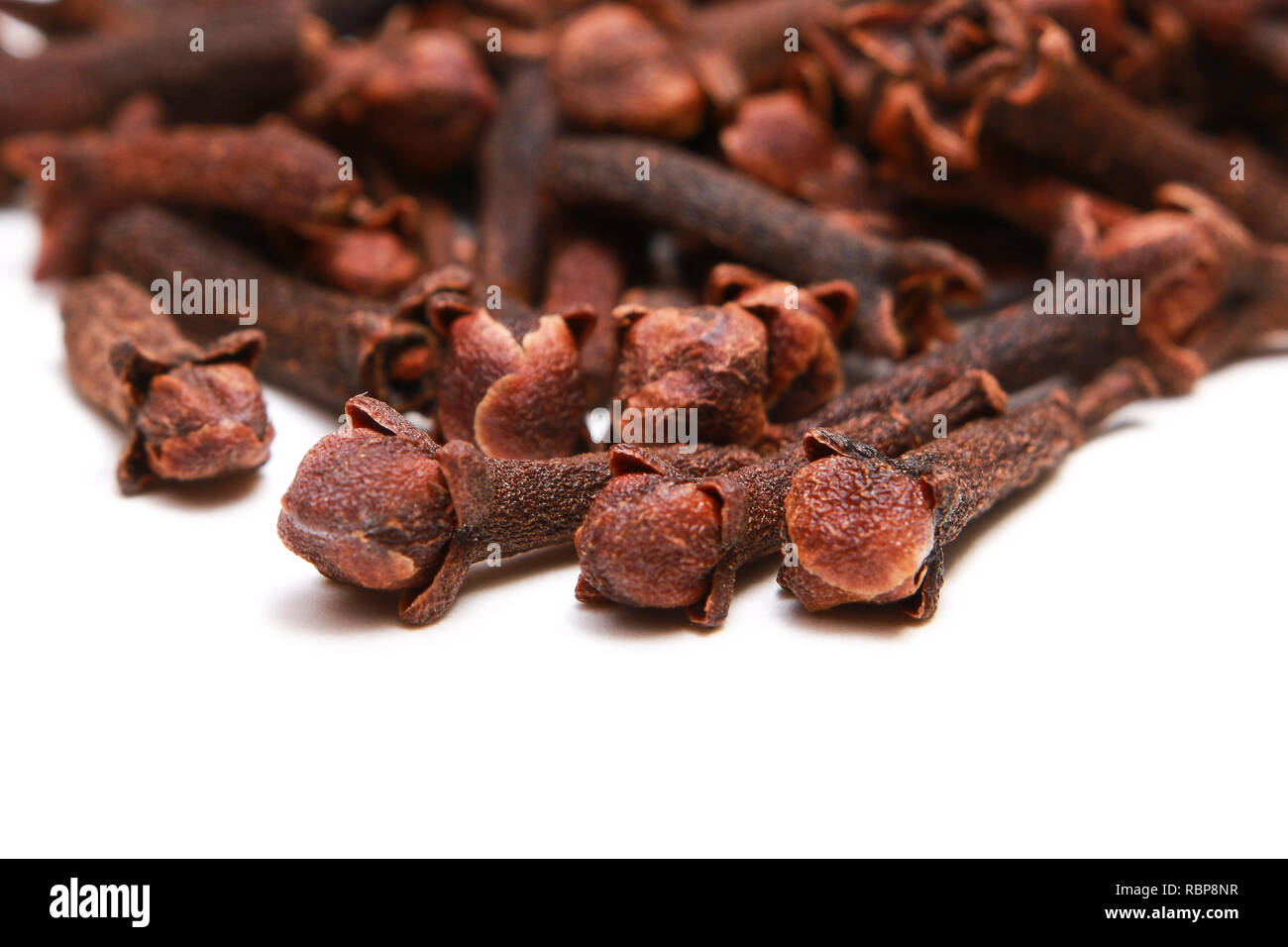 Whole Cloves on white background Stock Photo - Alamy