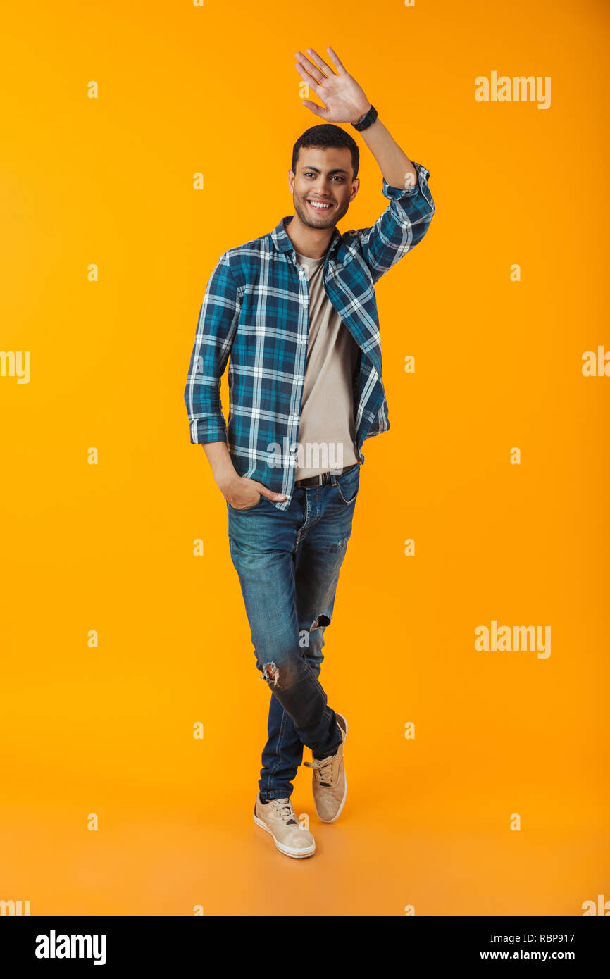 Full length portrait of a happy young man wearing plaid shirt isolated ...