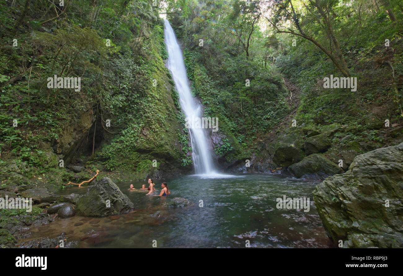 Tourists enjoying beautiful Kabigan Falls, Pagudpud, Luzon, Philippines ...