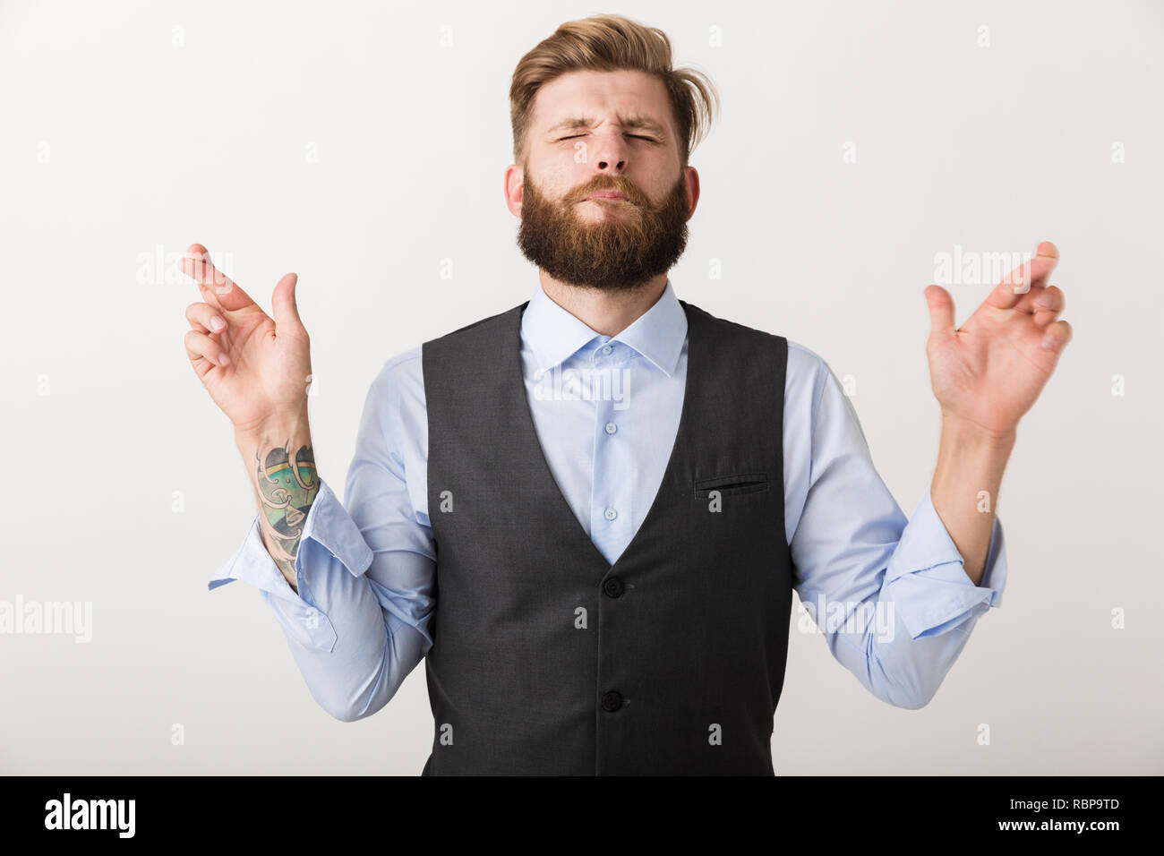Image of a handsome nervous young bearded man standing isolated over ...