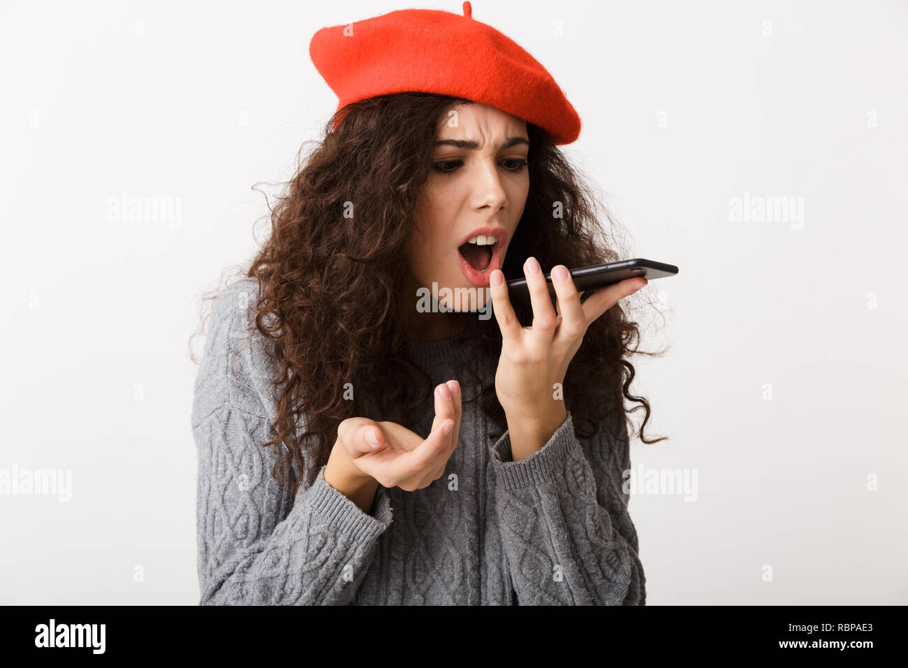 Angry young woman wearing autumn clothes standing isolated over white ...