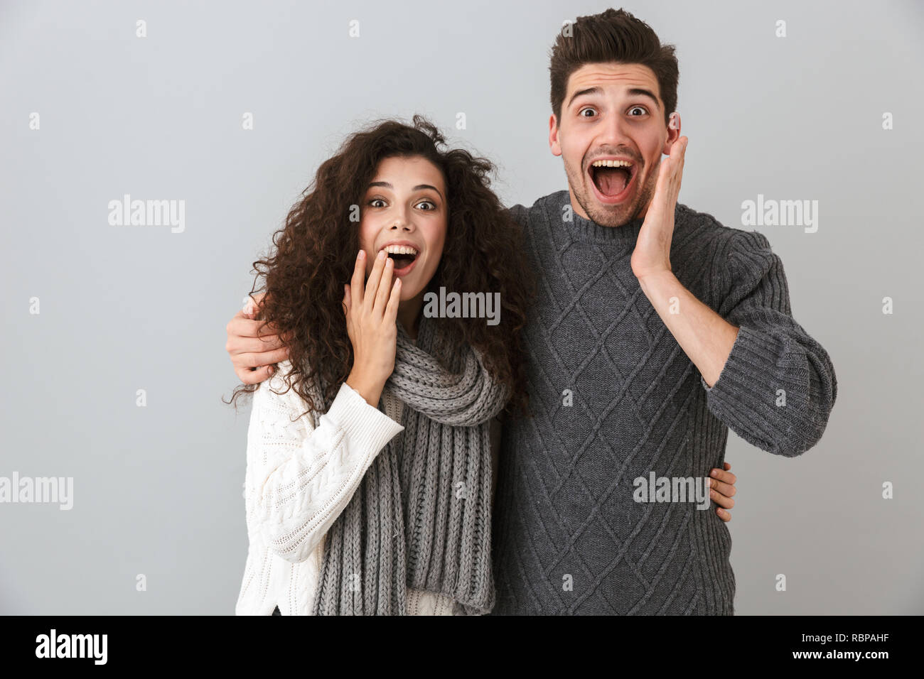 Photo of surprised couple man and woman screaming and touching face ...