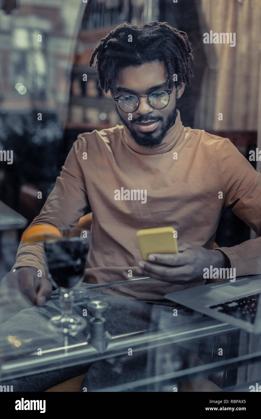 Cute brunette male person reading income message Stock Photo - Alamy