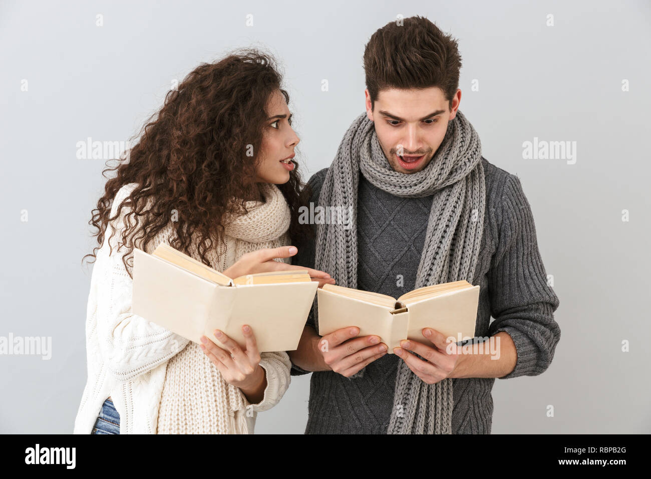 Image of smiling couple man and woman reading books together isolated ...