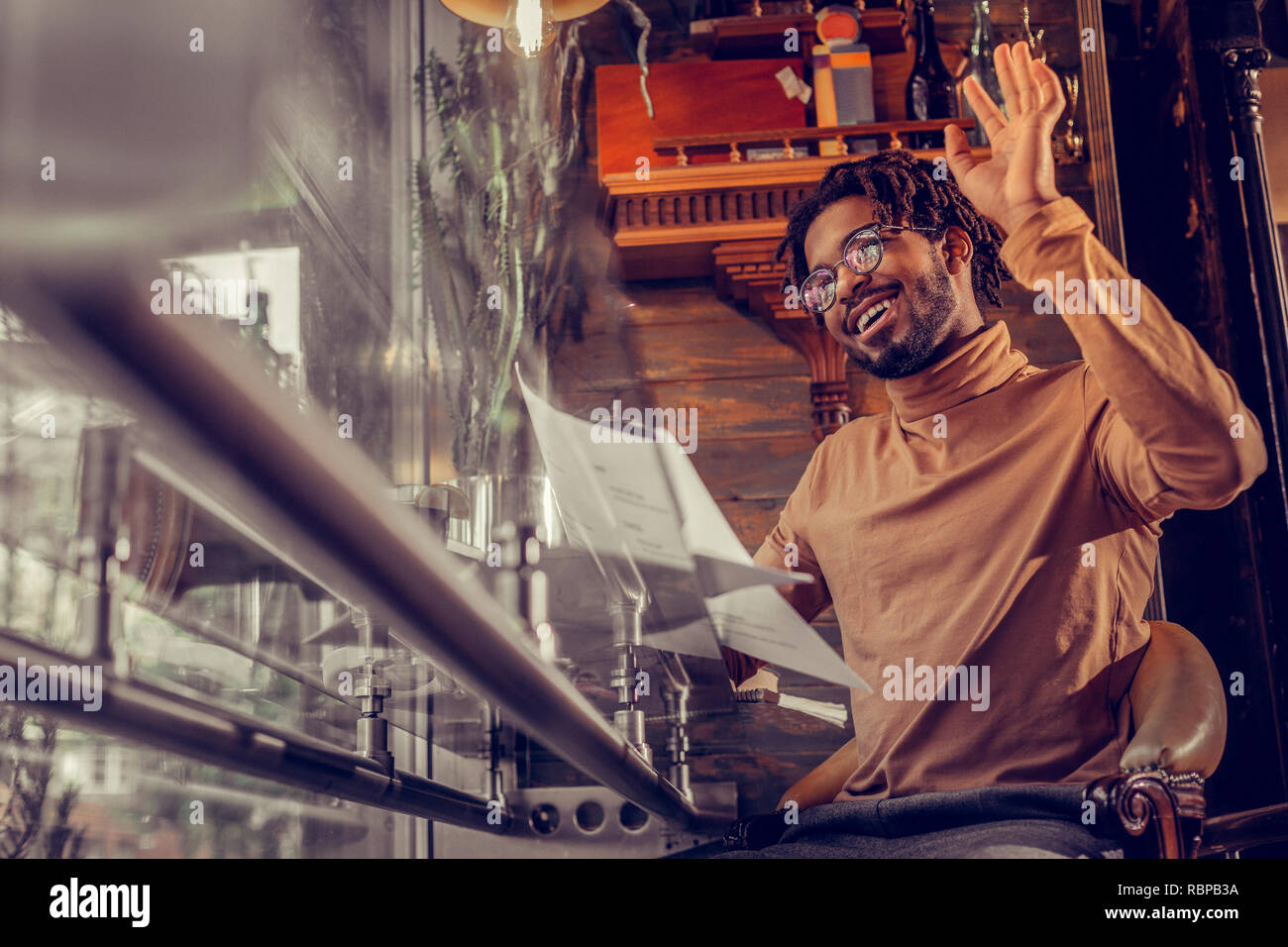 Positive delighted bearded man welcoming his friend Stock Photo - Alamy