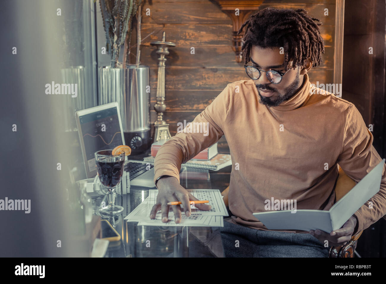 Concentrated stylish man checking documents for presentation Stock ...