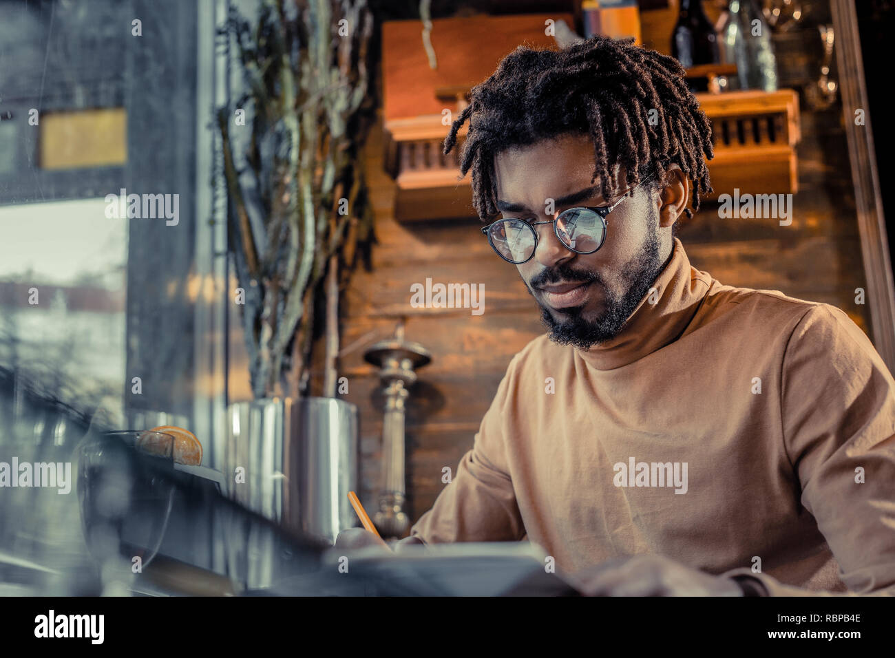 Concentrated young student completing task for lesson Stock Photo - Alamy