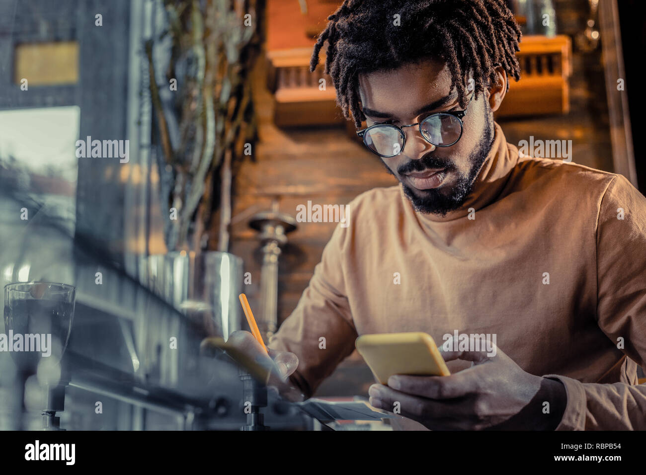Attentive brunette man checking news in internet Stock Photo - Alamy