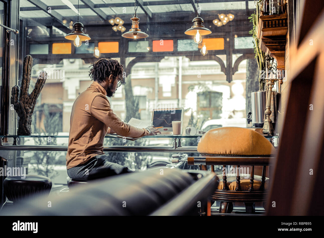 Attentive young man staring at screen of computer Stock Photo - Alamy