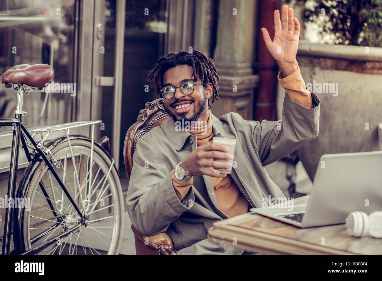 Handsome international male person waving his hand Stock Photo - Alamy