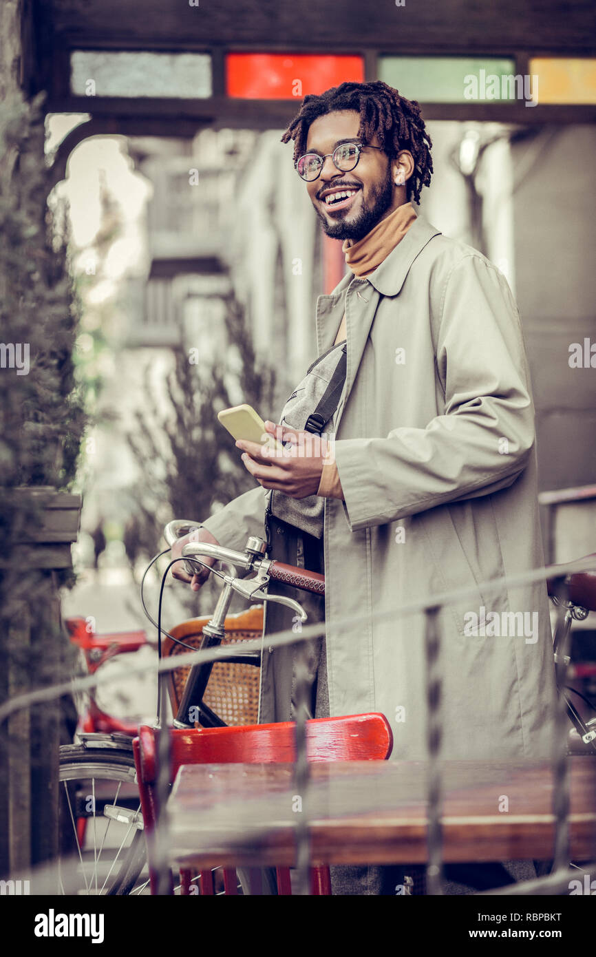 Happy international man standing in semi position Stock Photo - Alamy