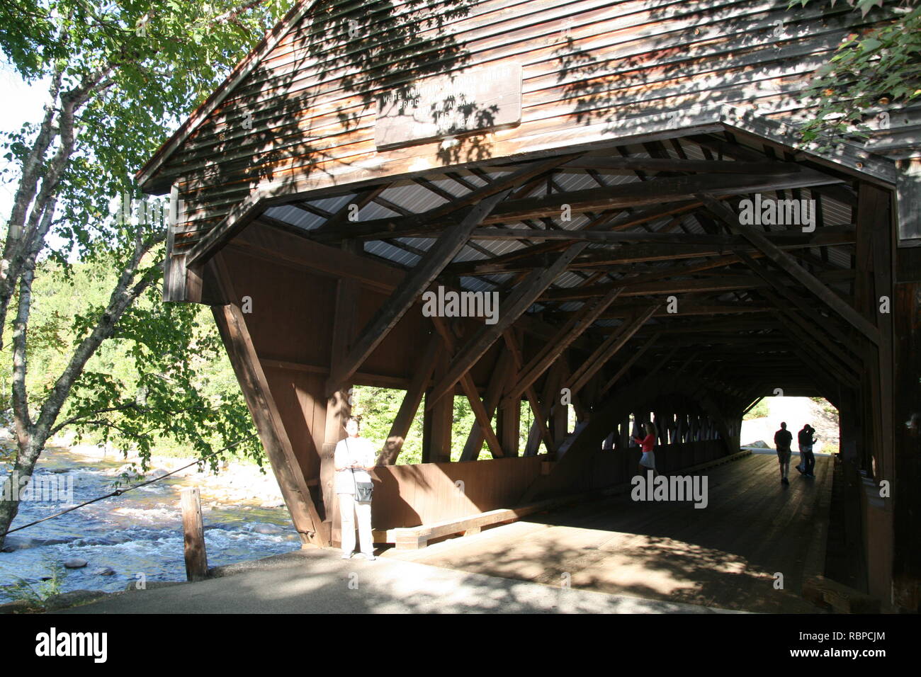 Sunlit view of Albany Covered Bridge and Swift River, Albany, New ...