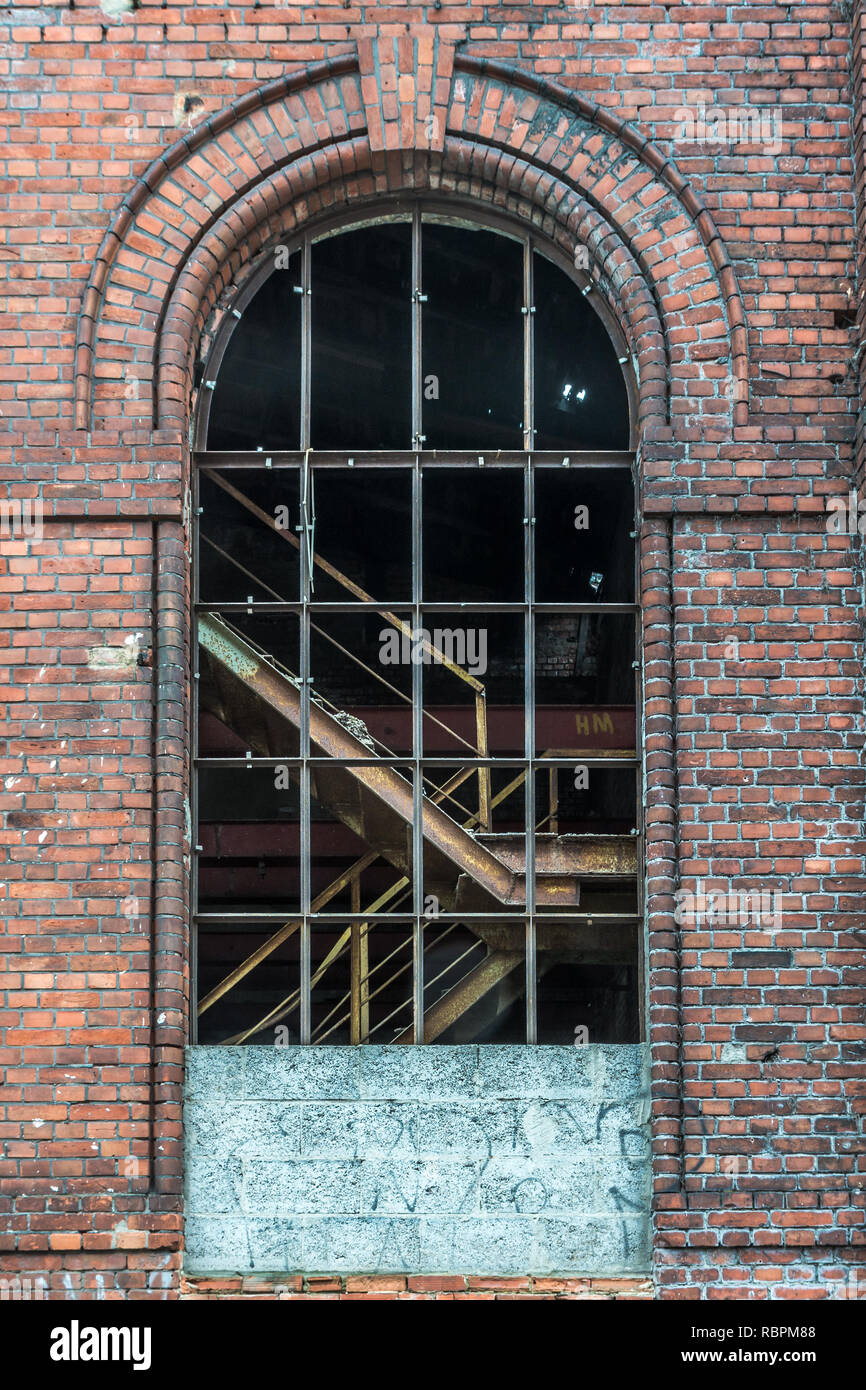 Żyrardów, Poland. Window with iron frame and red bricks wall of old ...