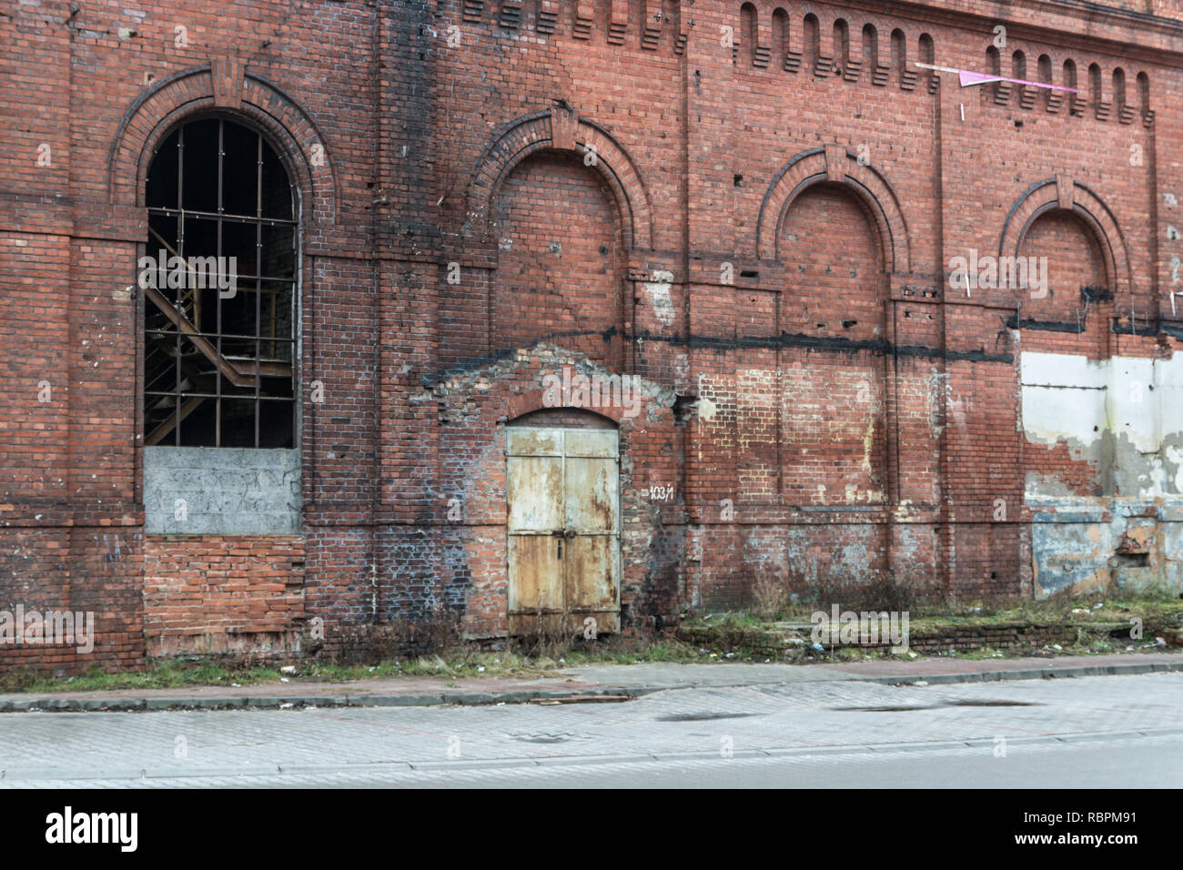 Żyrardów, Poland. Window with iron frame and red bricks wall of old ...