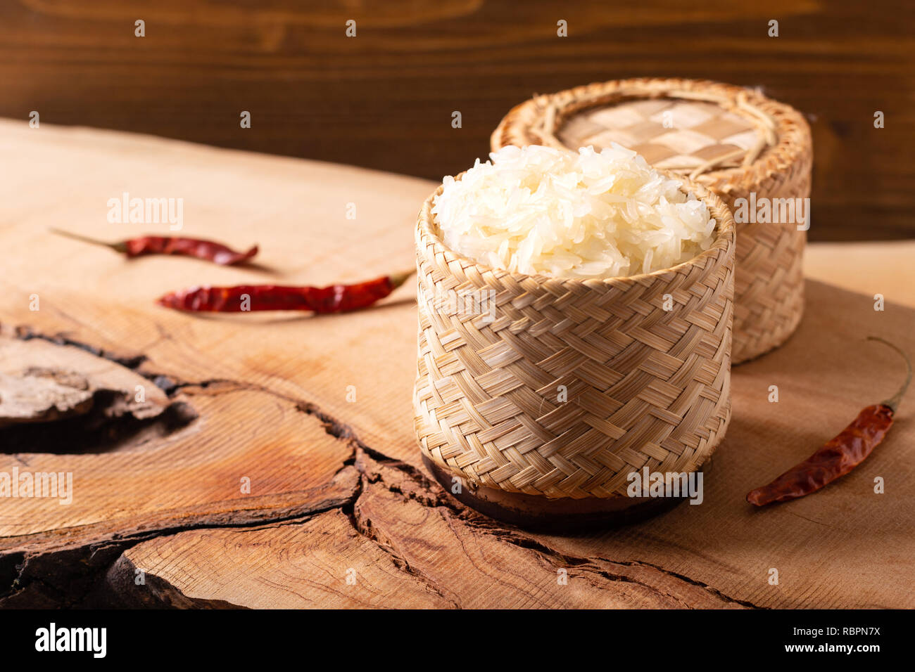 Asian Thai food Glutinous or sticky rice in bamboo wicker on wooden ...