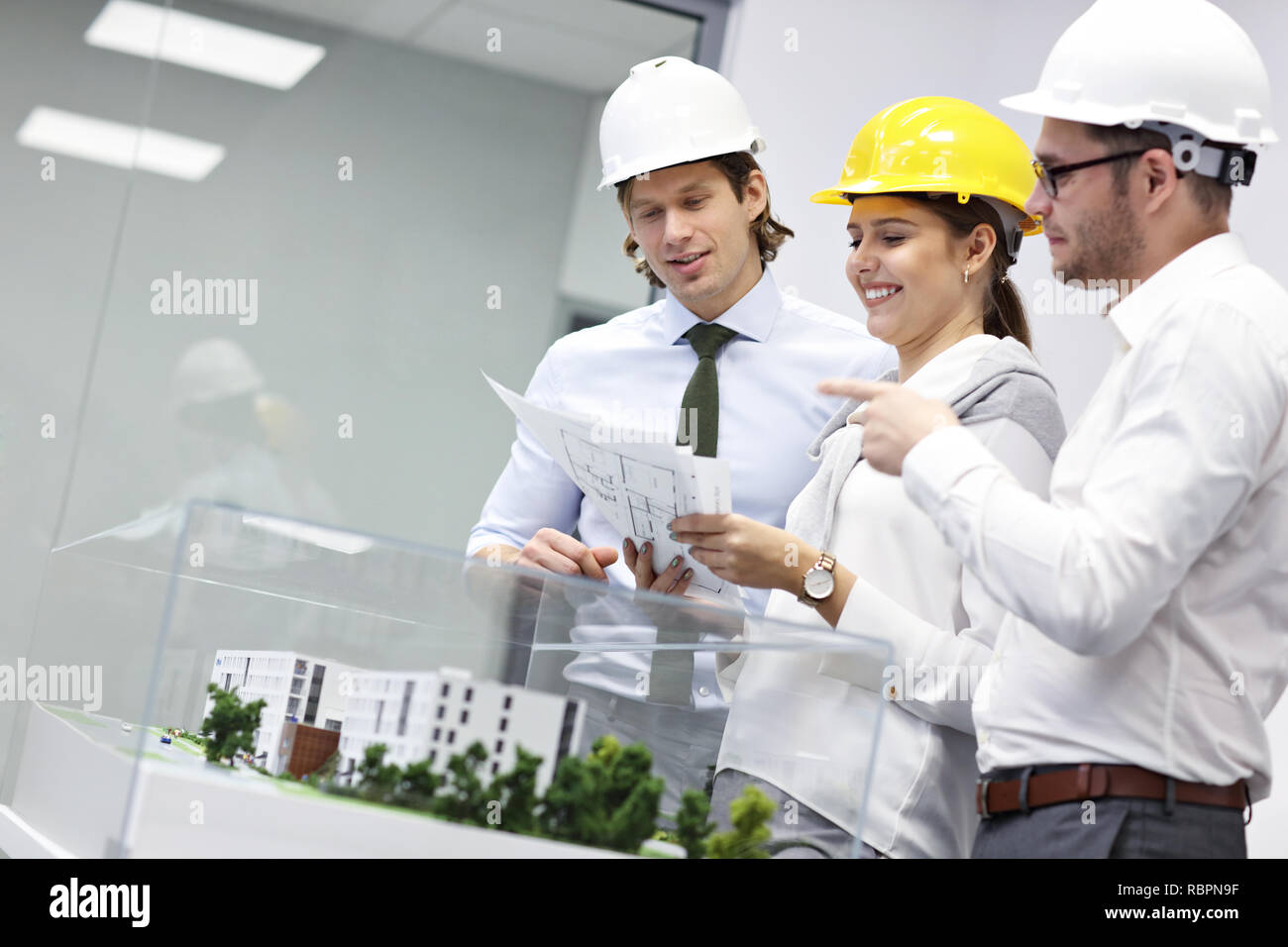 Group of architects sharing ideas in modern office Stock Photo - Alamy