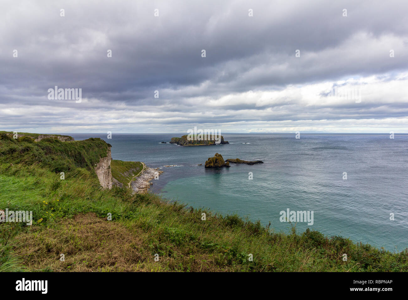 View of the dramatic Causeway Coast in Northern Ireland under a cloudy ...