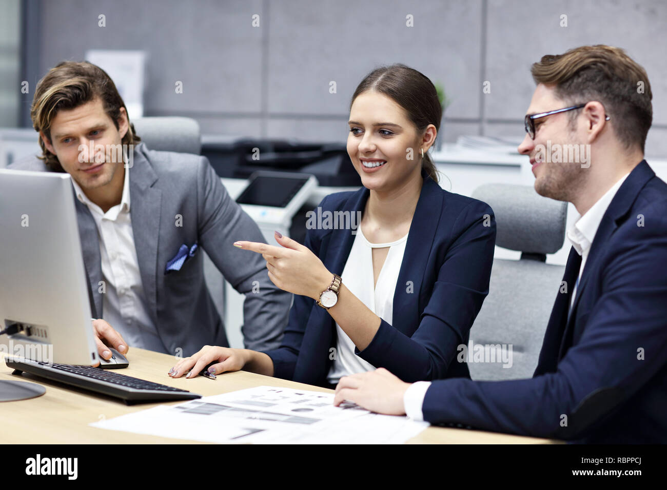Three people exchanging documents hi-res stock photography and images ...