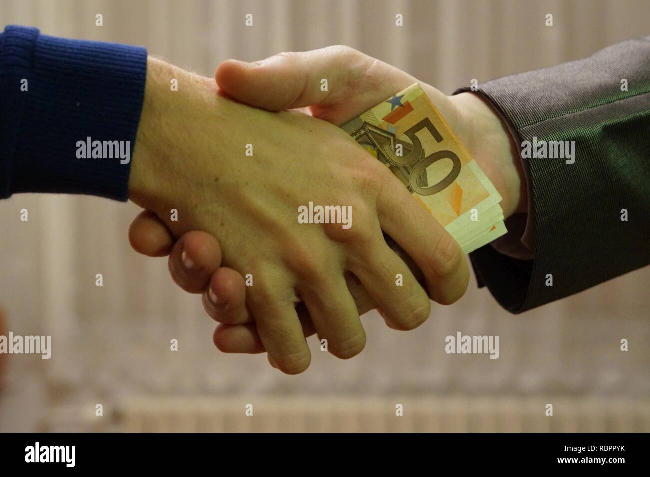 10 - hands shaking with euro bank notes inside handshake Stock Photo ...
