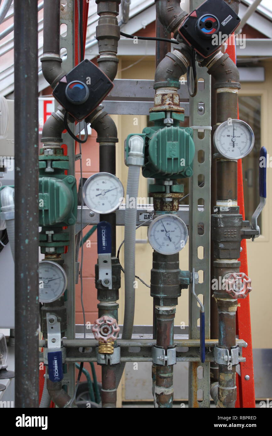 Behind the scenes display of pipes, valves, and gauges Stock Photo - Alamy
