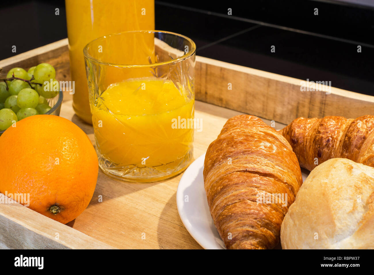 breakfast tray with orange juice croissants and fruit Stock Photo - Alamy
