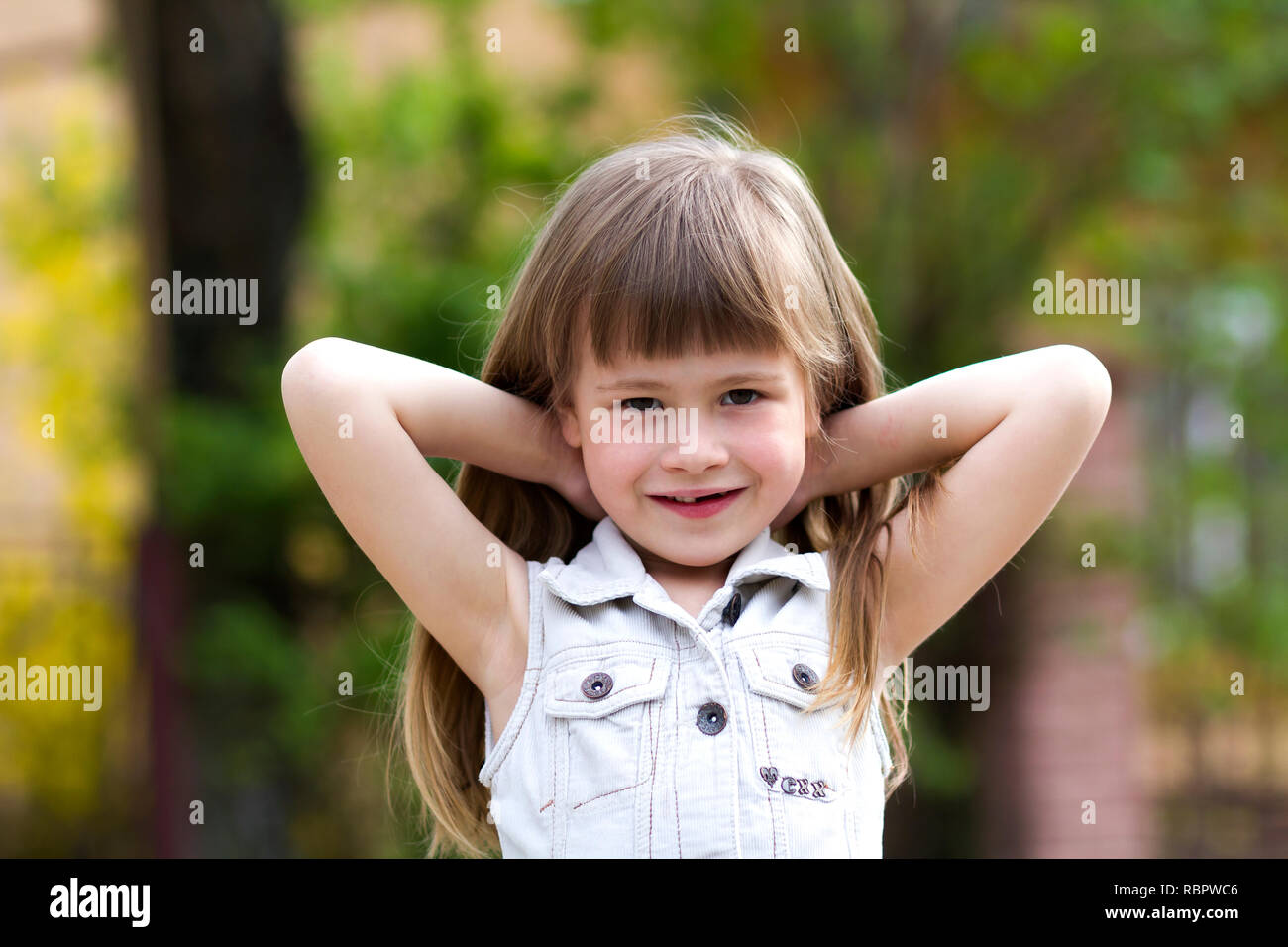 Portrait of a pretty little long-haired blond preschool girl in ...