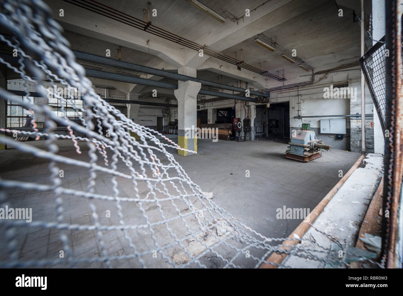 Looking through a open wireframe at a window into an abandoned factory ...