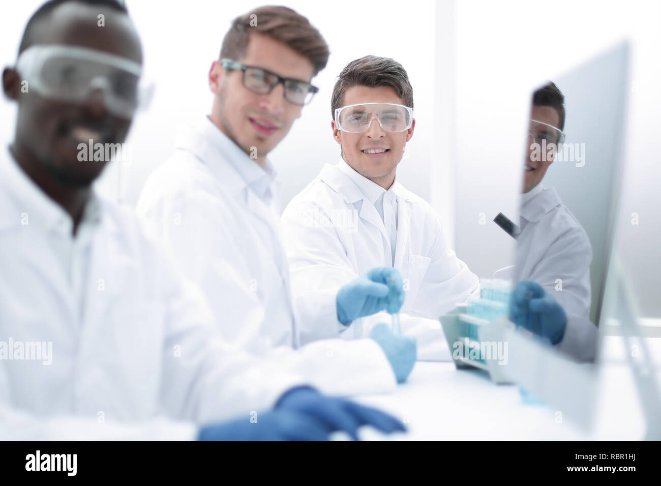 successful group of scientists sitting at their Desk Stock Photo - Alamy