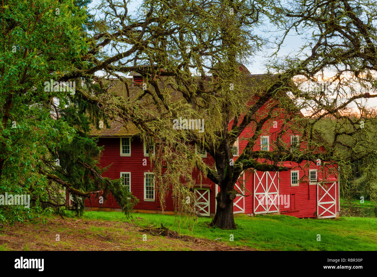 An old red barn sits on a hillside of a wildlife refuge in rural Oregon ...