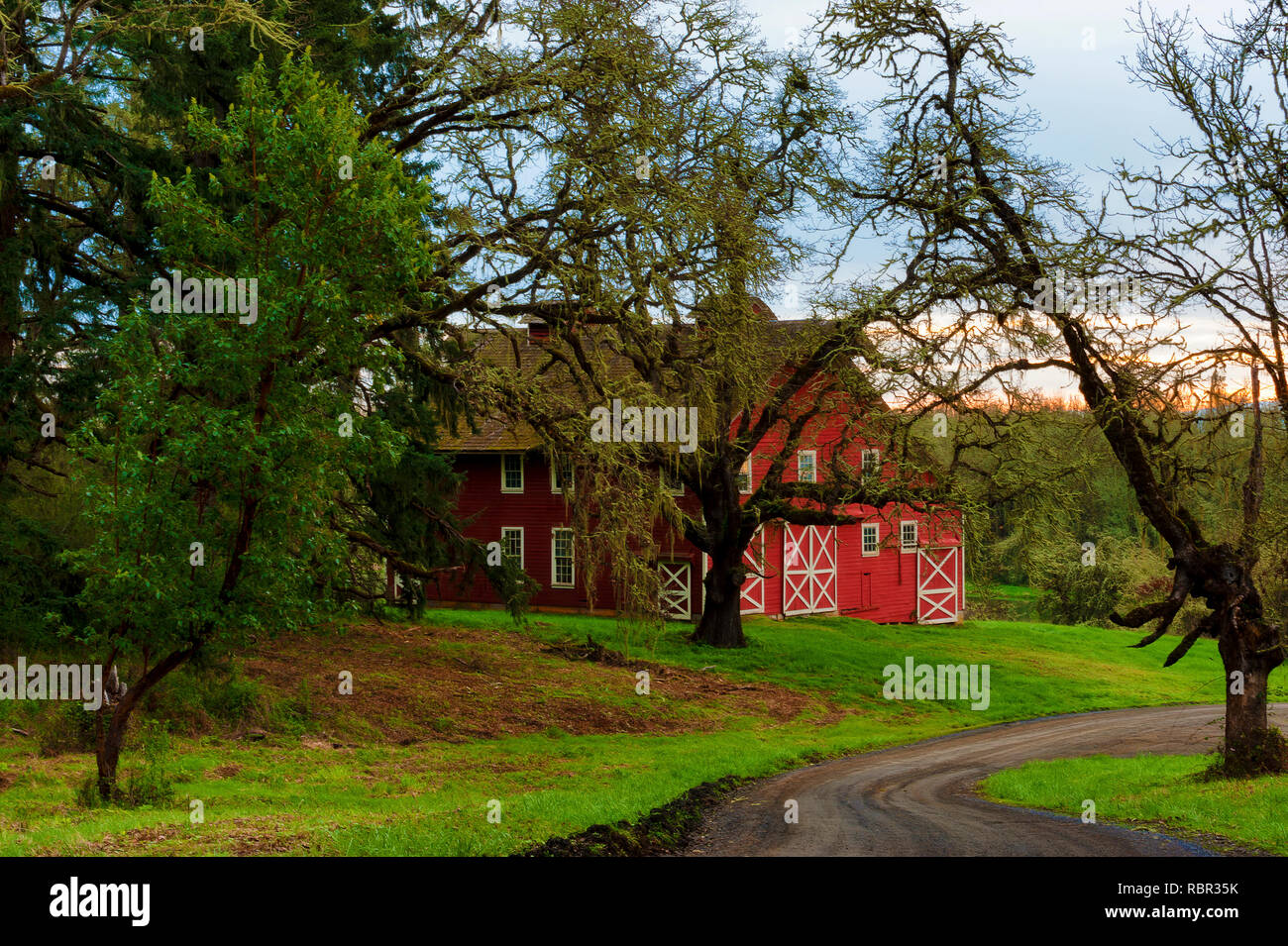 An old red barn sits on a hillside of a wildlife refuge in rural Oregon ...