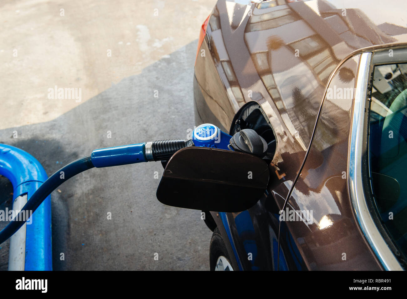 Super 95 E10 sing on the pumping gasoline fuel in car at gas station ...