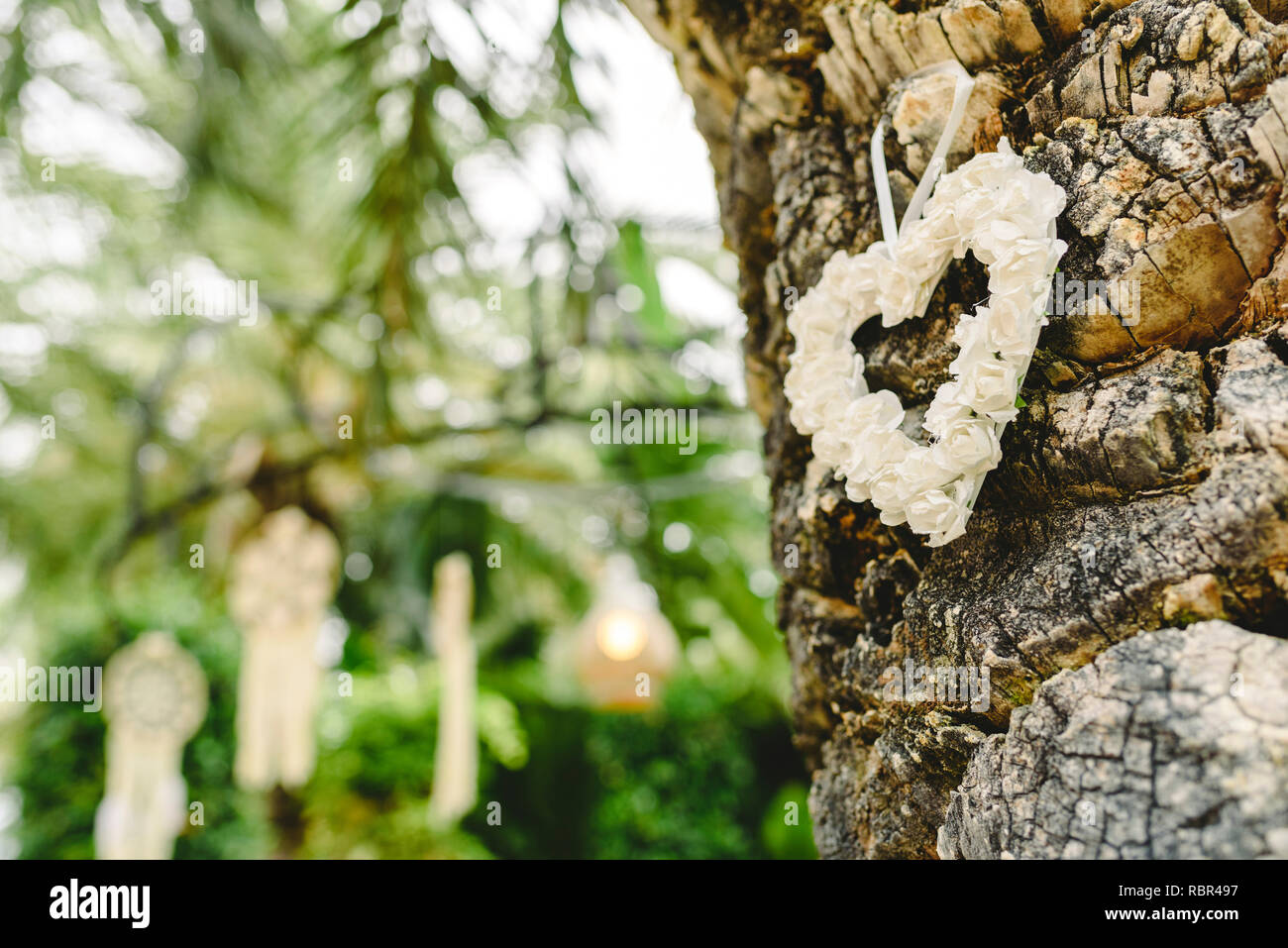 Heart of flowers hanging from a tree as decoration Stock Photo - Alamy