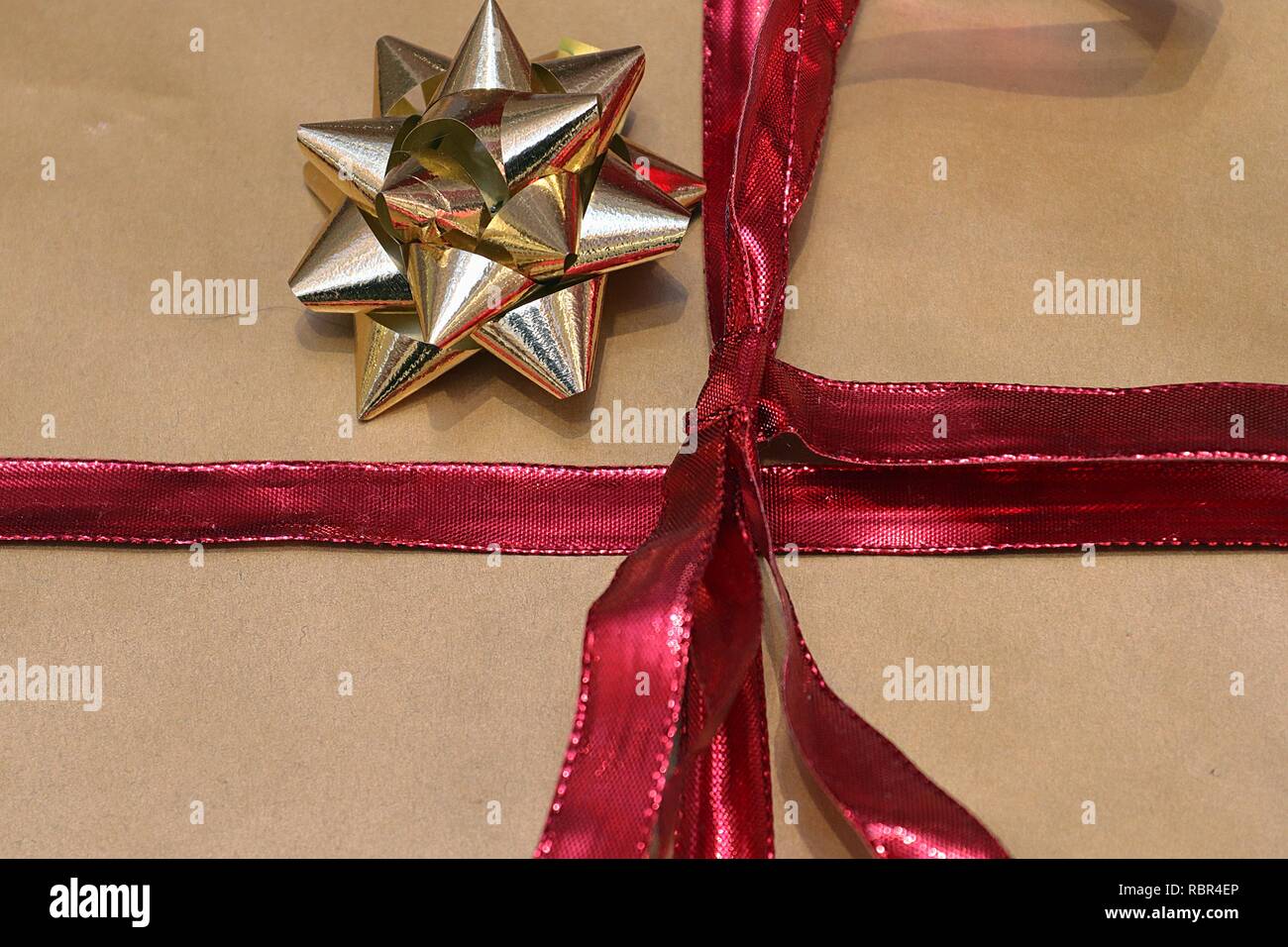 Beautiful wrapped gift in golden and red colors Stock Photo - Alamy