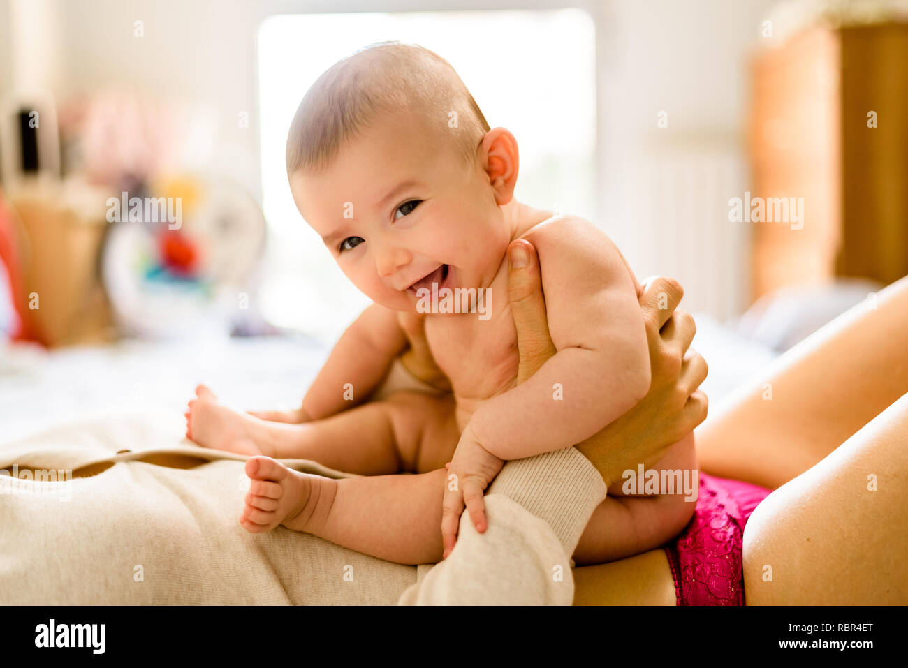 Nice newborn baby laughing Stock Photo - Alamy