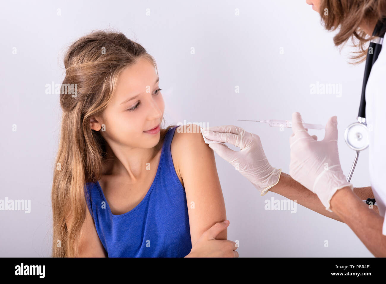 Close-up Of A Doctor Injecting Syringe To Patient Arm In Clinic Stock ...