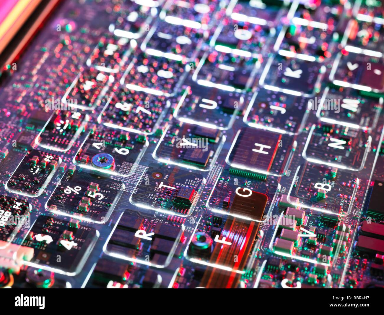 Double exposure of a laptop computer keyboard showing the electronics ...