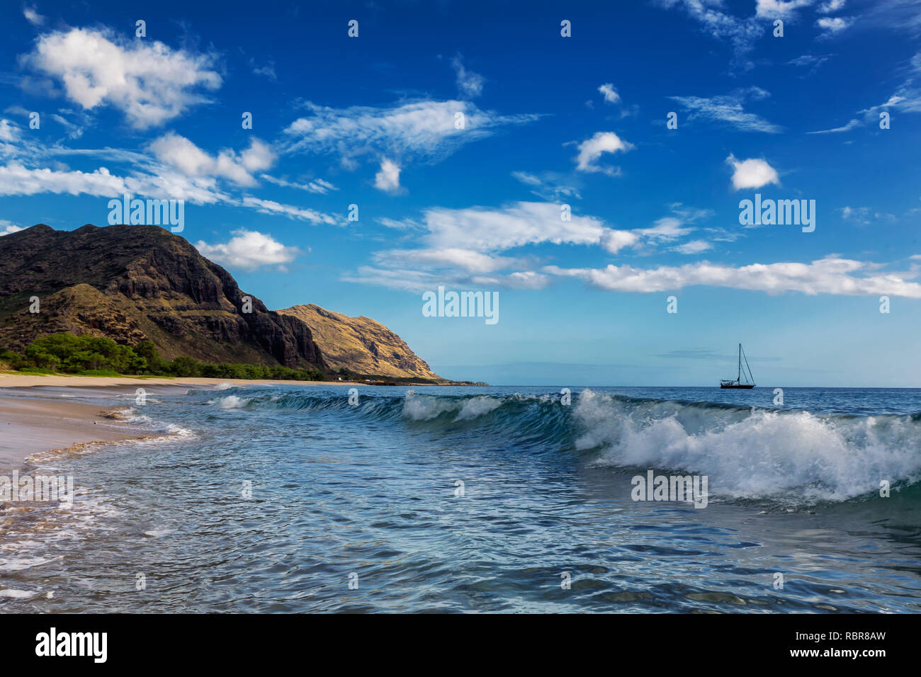 Makua beach view of the wave with beatiful mountains and a sailboat in ...